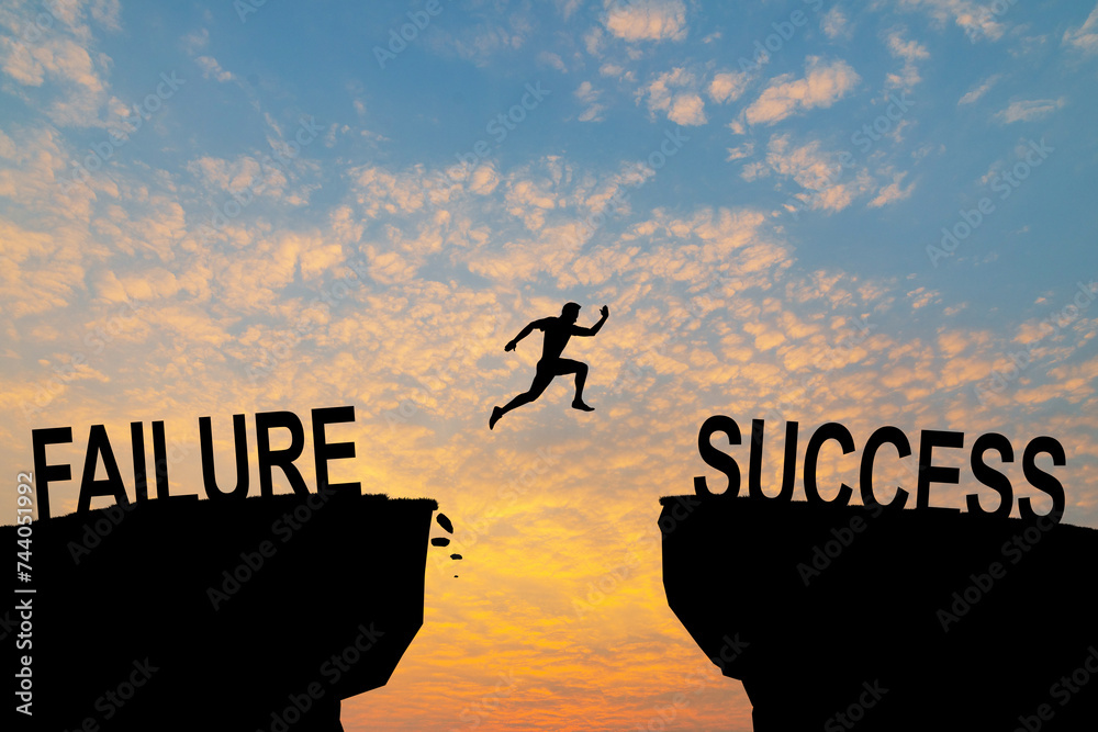 Man jump across text failure to success over cliff on sunset background ...