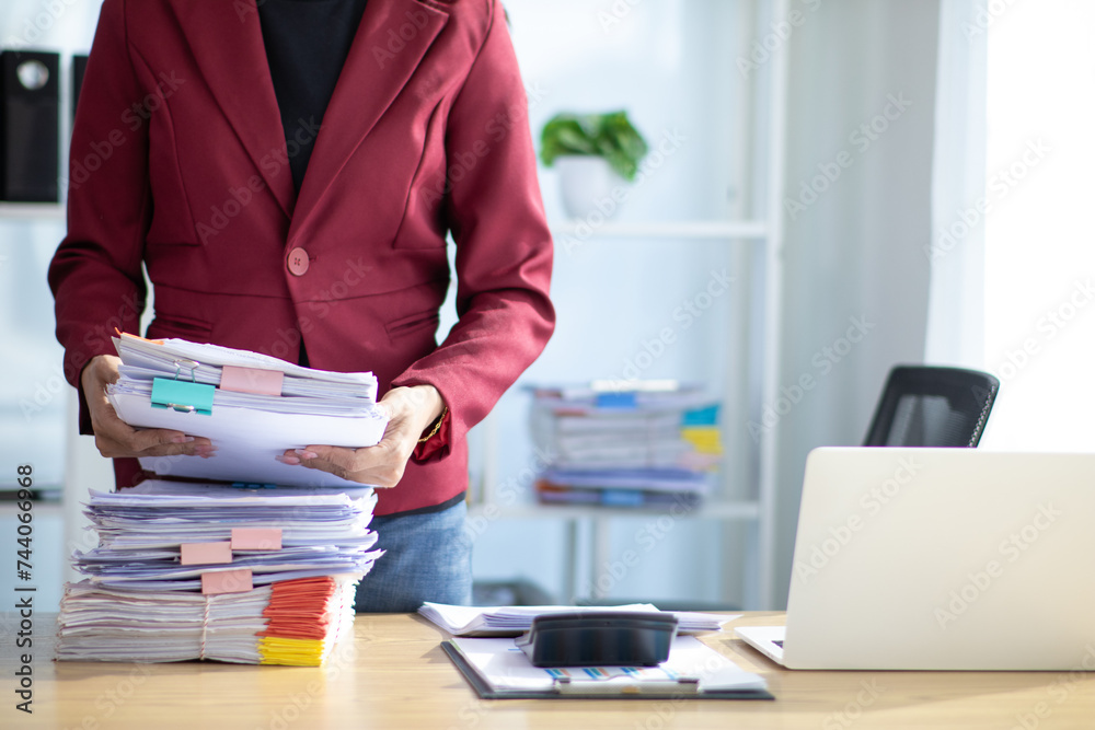 secretary is searching through pile of important documents on office ...