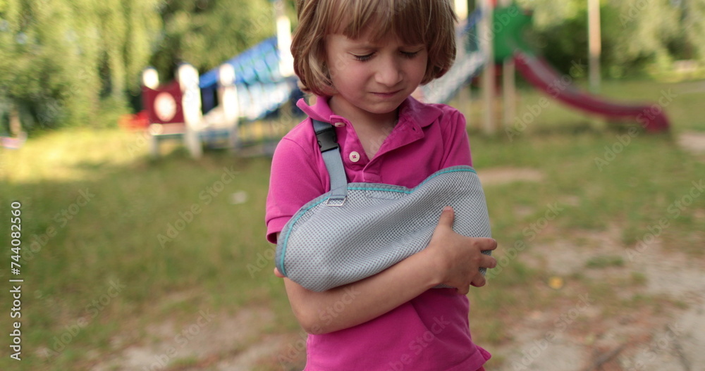 Foto de Sad child outdoors with a broken limb small, injured boy. The ...