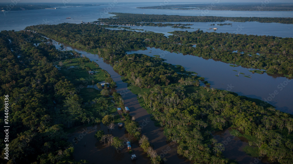 Aerial view of a flooded area (igapó) and houses on stilts, based on ...