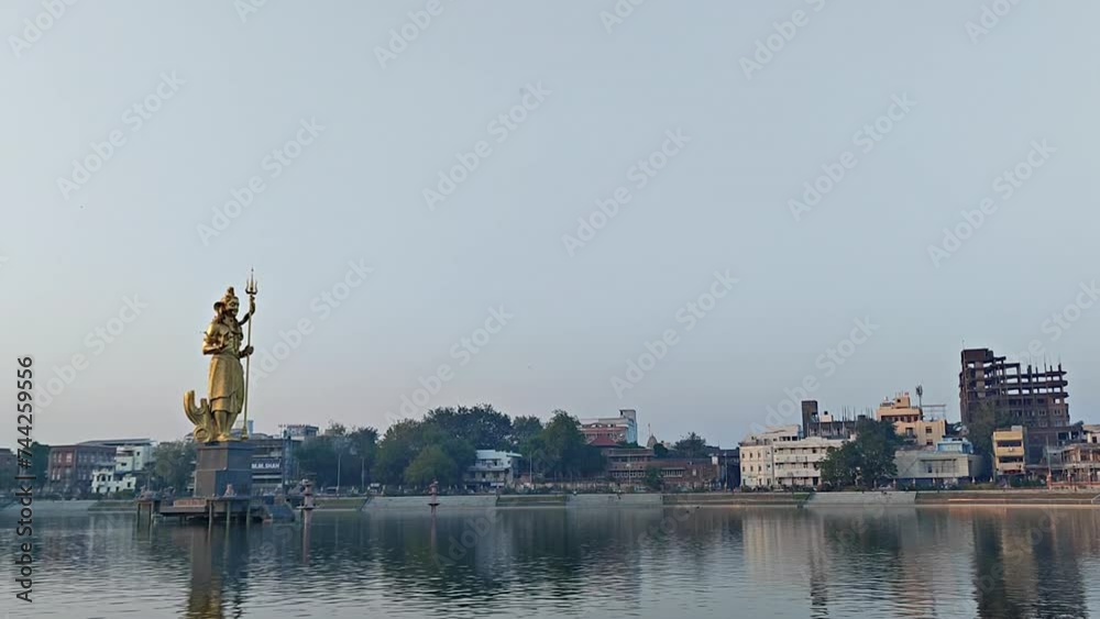 Capture the beauty of a side view of the magnificent gilded Lord Shiva ...