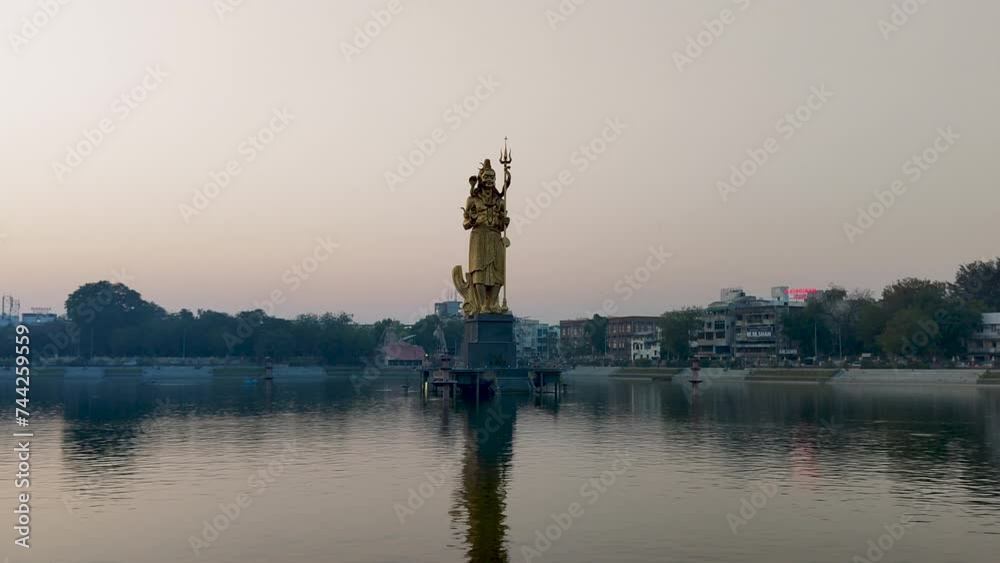 Enjoy a breathtaking front view of the immense gilded Lord Shiva statue ...