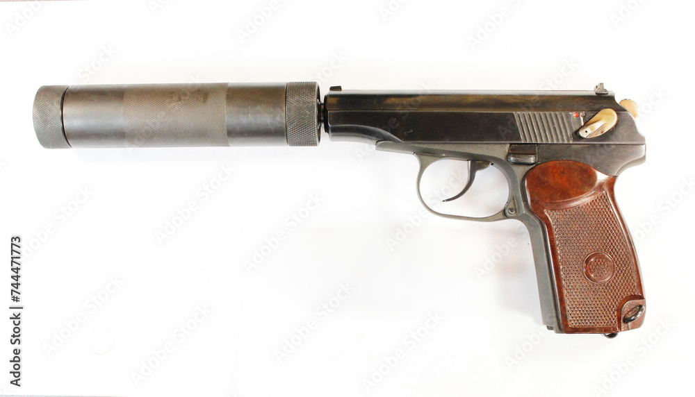 Pistol with a silencer on a white background with a scale ruler ...