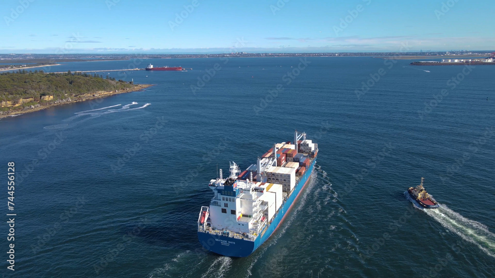 Aerial view of a large cargo container ship entering Botany Bay at the ...