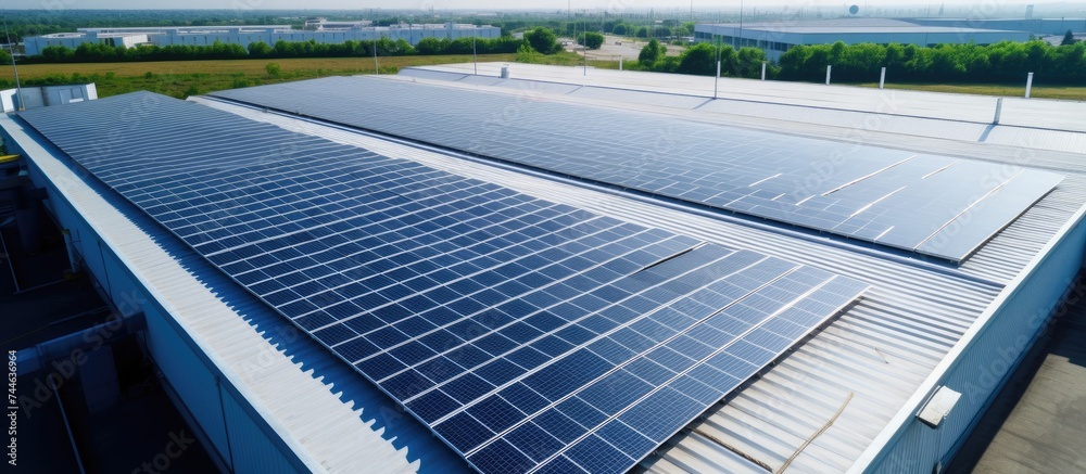 Top view photo of solar panels PV modules on warehouse roof capturing sunlight to generate ...