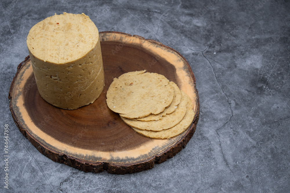 Vegan ham made in ham mold, sliced, wooden board. Mock vegan meat as ...