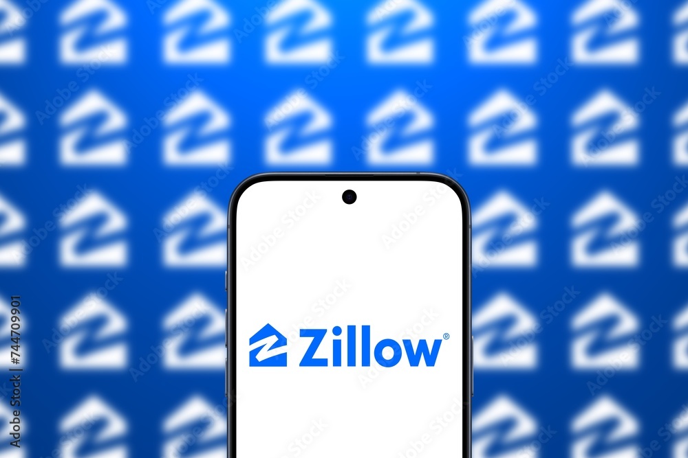 Zillow logo is displayed on a smartphone, white Zillow Logos in the ...