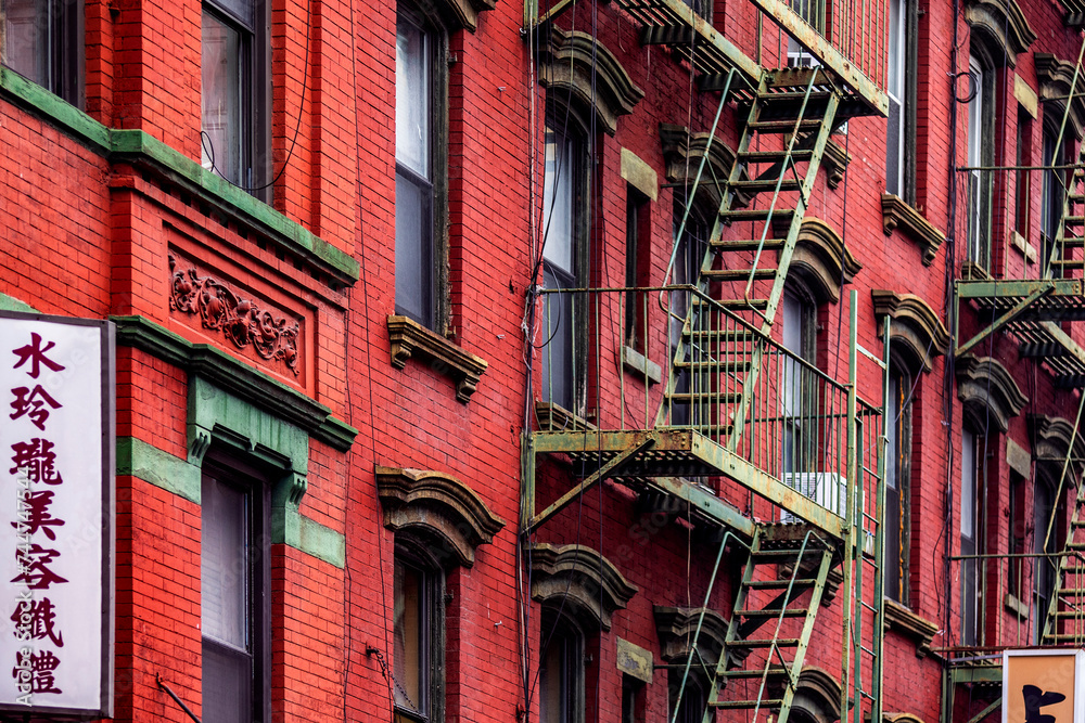 Typical red brick facade with emergency stairs of Chinatown in New York ...
