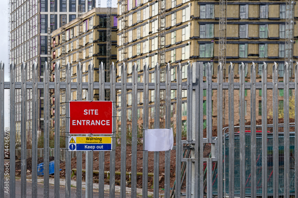 Site entrance sign on fence boundary at construction site Stock Photo ...
