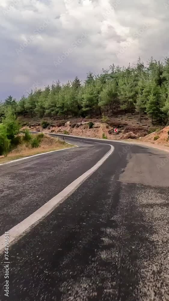 Drive with speed on serpentine mountain and forest roads, capturing ...