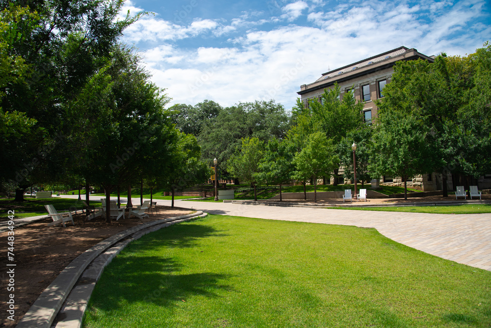 Brick walkway and outdoor seating with adirondack chairs under canopy ...