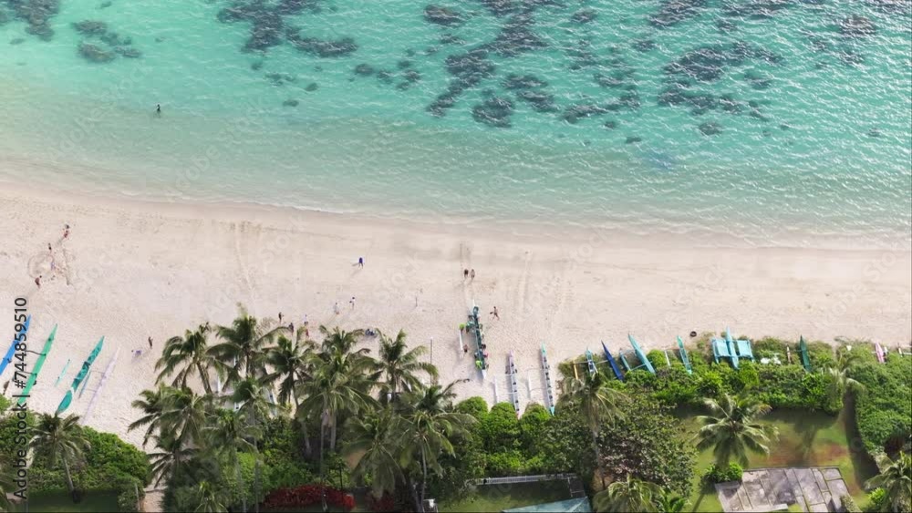 Top down aerial Lanikai canoe club team returning canoes to beach ...