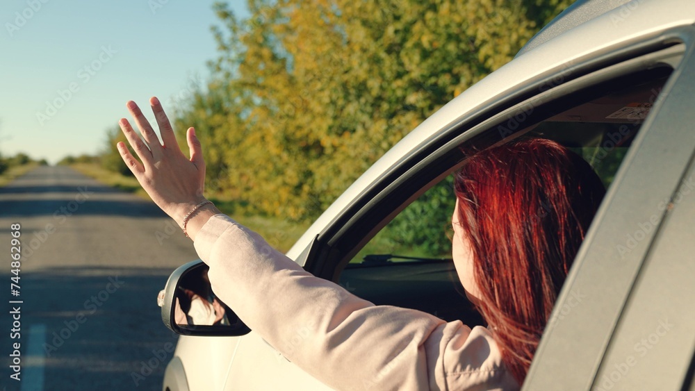 girl rides car with her hand out window, opens window, pulls his face ...