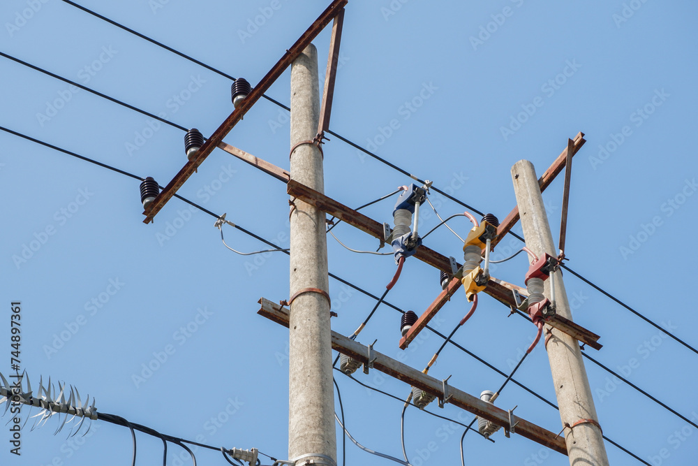 moving or diverting or electric current jumpers on electricity poles ...