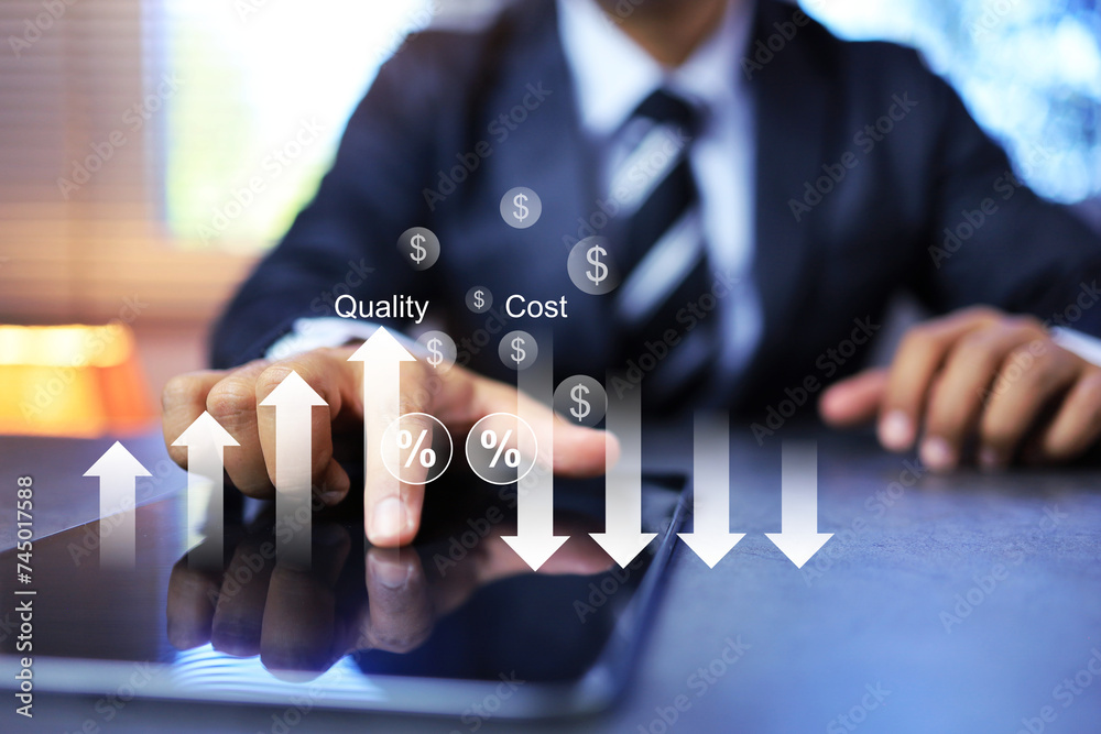 Increasing quality and reducing cost with businessman working on tablet ...