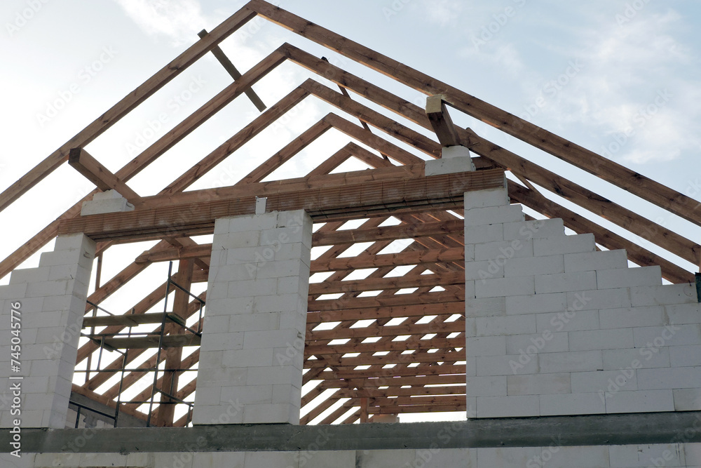 An "A" frame timber roof truss in a house under construction seen from ...