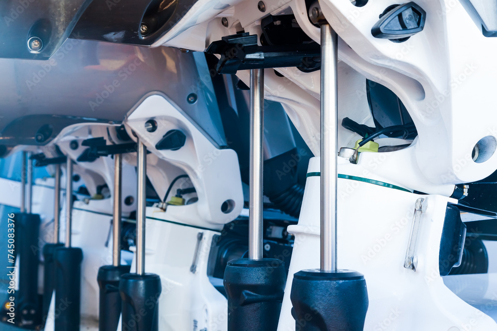 Lifting mechanisms on outboard motors at the stern of the boat. Transom ...