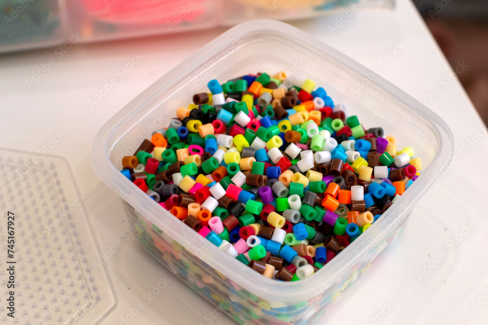 Container with many colorful fusible plastic perler beads Stock Photo ...