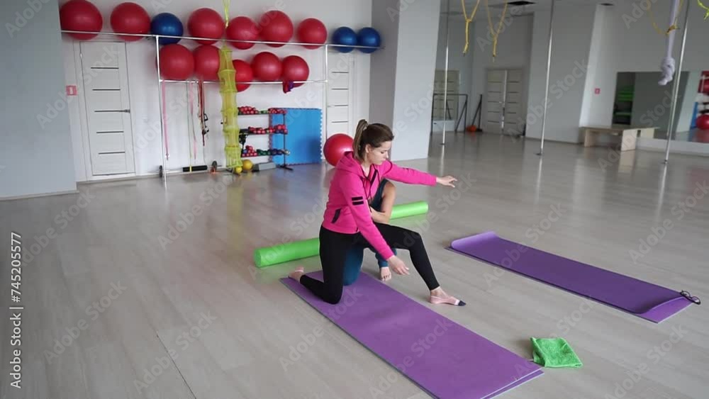 Personal trainer corrects the correctness of a woman performance of ...