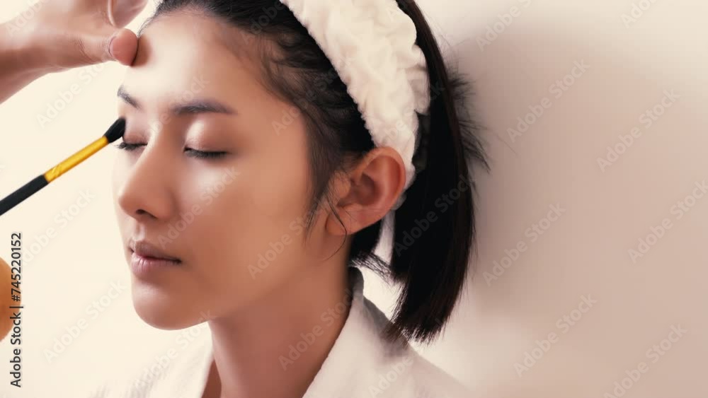 Make up artist applies makeup to left upper eyelid Makeup artist ...