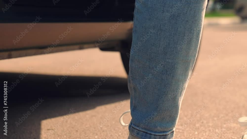 Legs woman walk to car close-up. Rear view legs woman getting in car ...