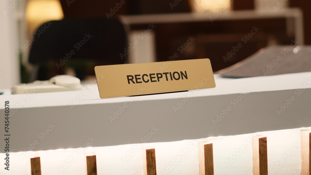 Blurry revealing extreme close up shot of reception sign on empty clean ...