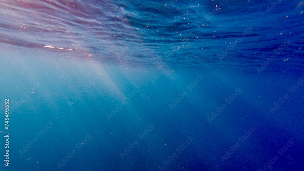 Sun rays underwater. The sun's rays pass through the water at an angle ...