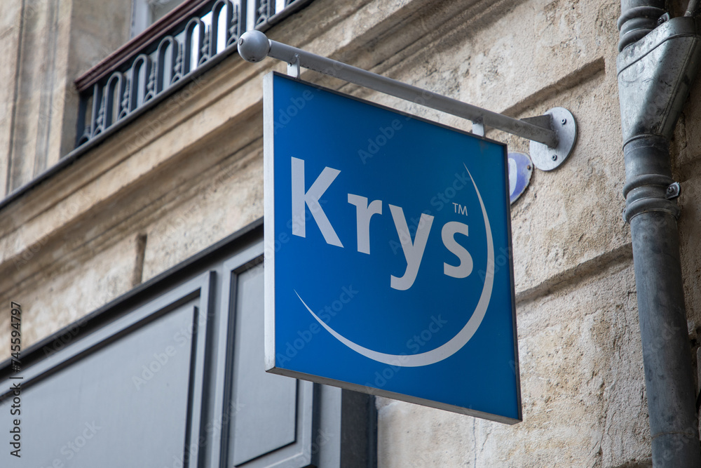 krys brand text chain and sign logo store facade wall entrance of ...