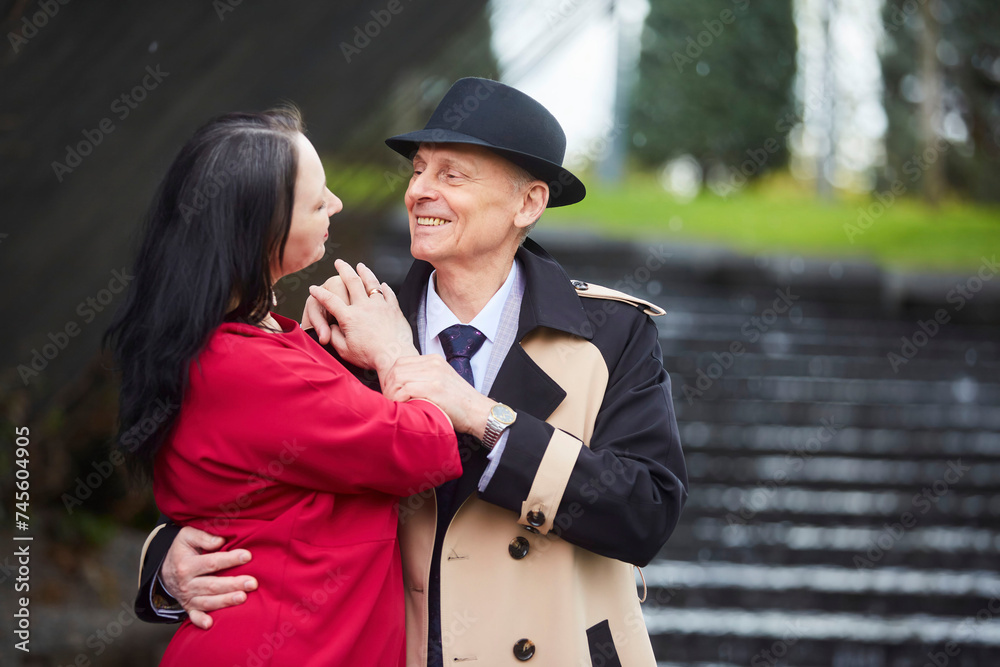 Beautiful older adult married couple in the park. Love and feelings in ...