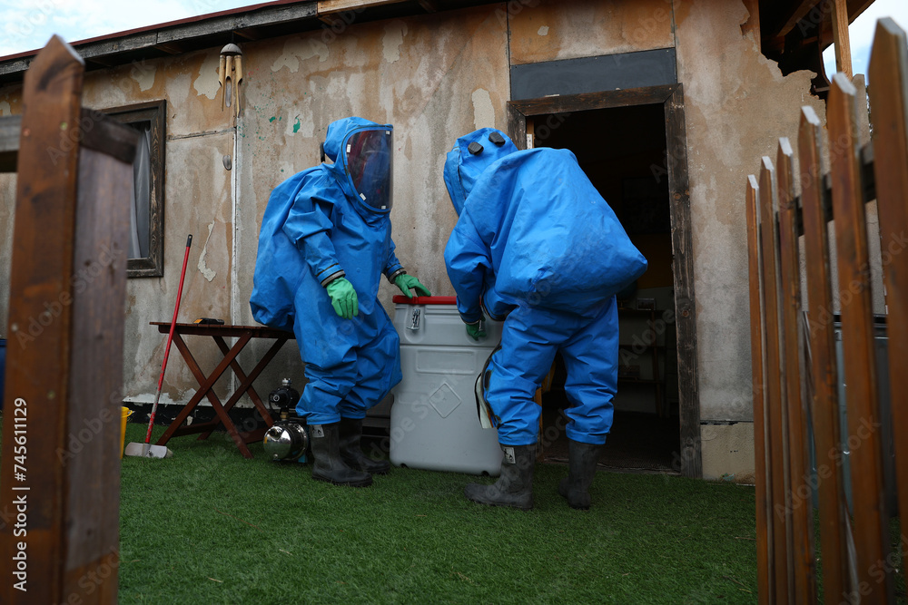 People wear blue Personal protective equipment (PPE) with gas mask for ...