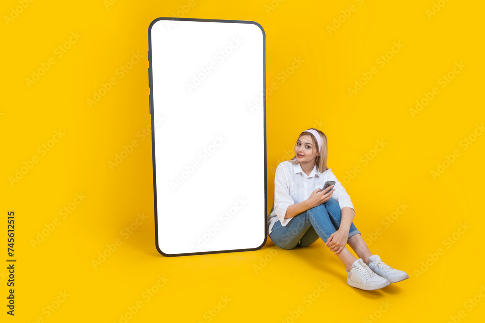 Mobile app mock up, full body length young blonde girl sit near huge ...