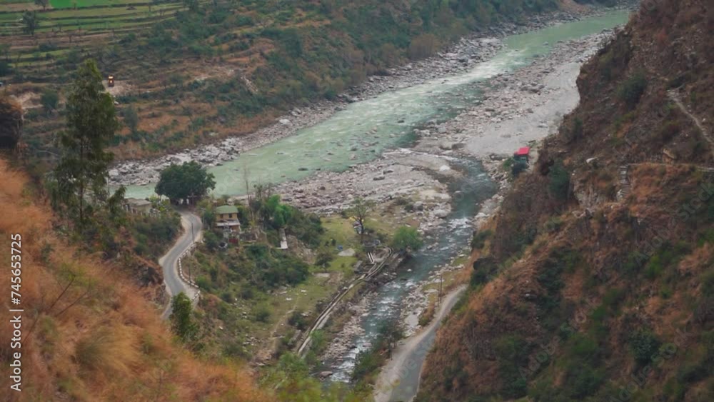 Tirthan river flowing in between the mountains at Tirthan Valley in ...