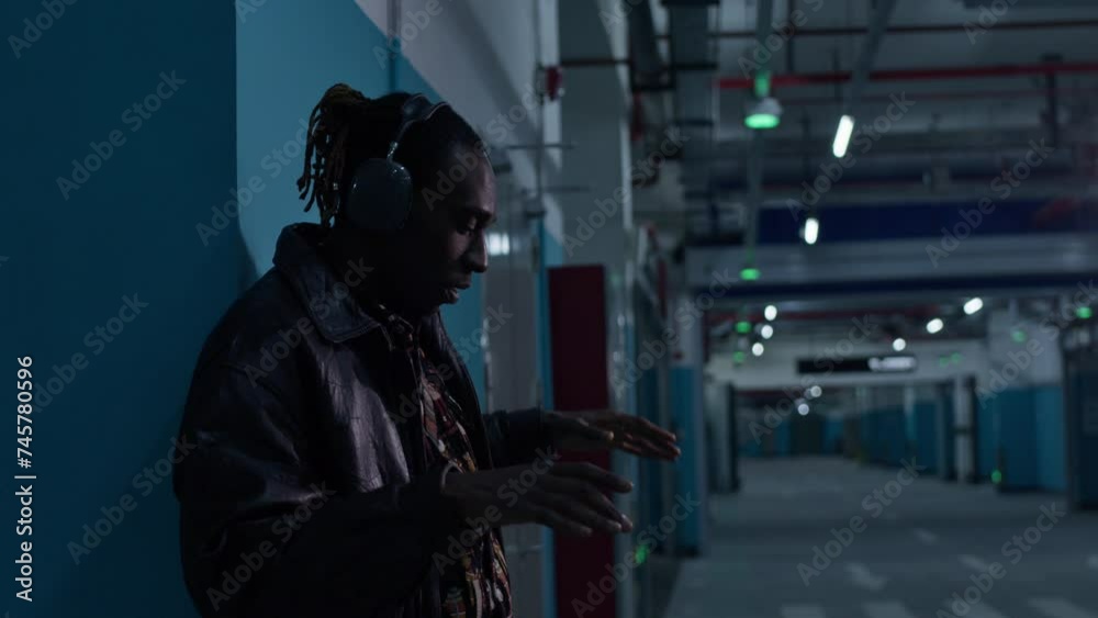 Afro-American black musician rapper, wearing headphone in underground ...