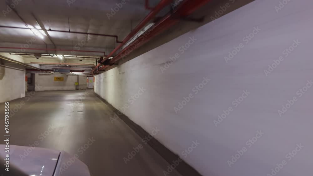 car driving through an indoor mall parking garage with directional ...