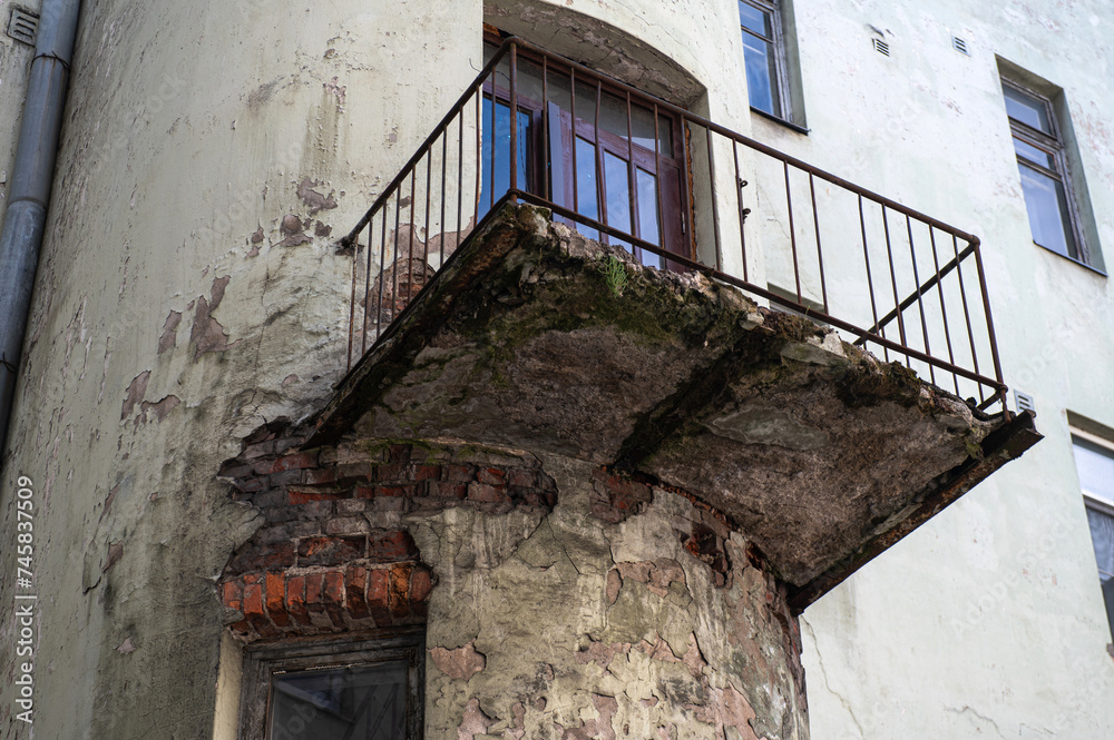 dangerous balcony in an old residential building. The concrete slab is ...
