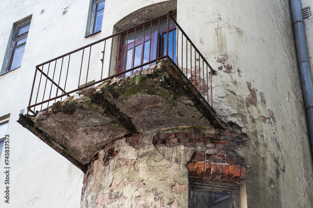 dangerous balcony in an old residential building. The concrete slab is ...