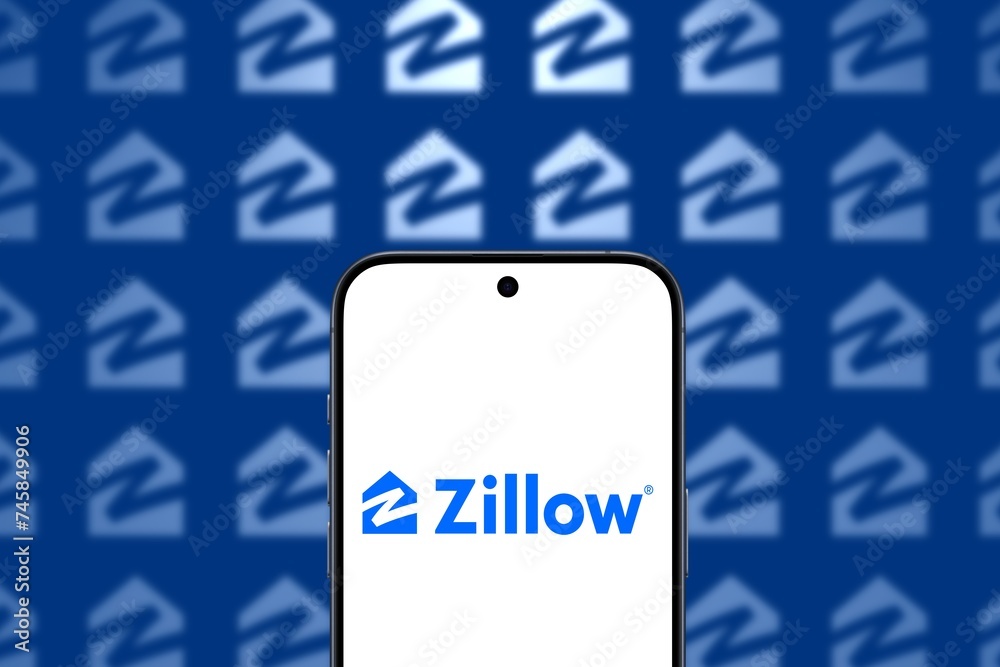 Zillow logo is displayed on a smartphone, white Zillow Logos in the blue background, Online real ...