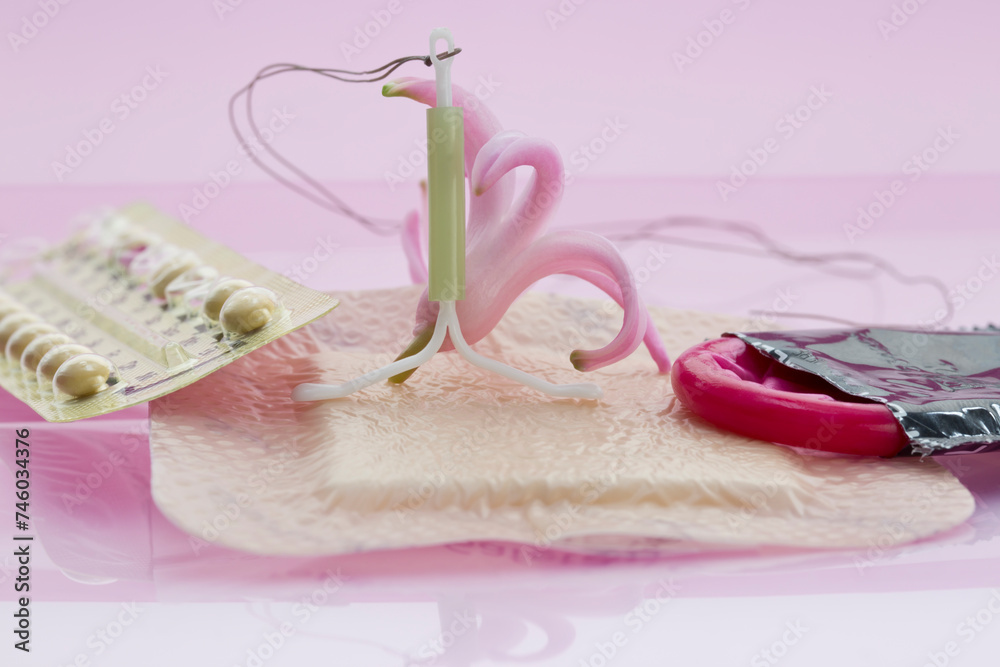 Birth control methods. Intrauterine system leaning on pink hyacinthus ...