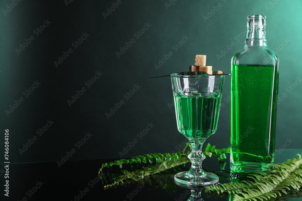 Absinthe, brown sugar and green leaves on mirror table, space for text ...