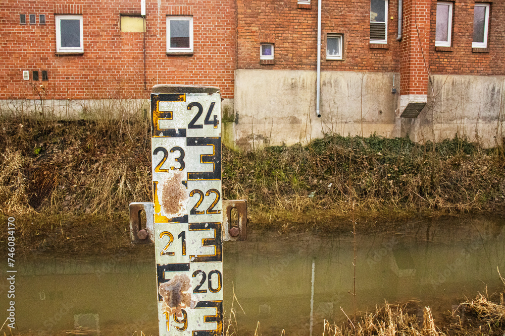 old sea gauge pressure gauge on the river bank, measuring the water ...