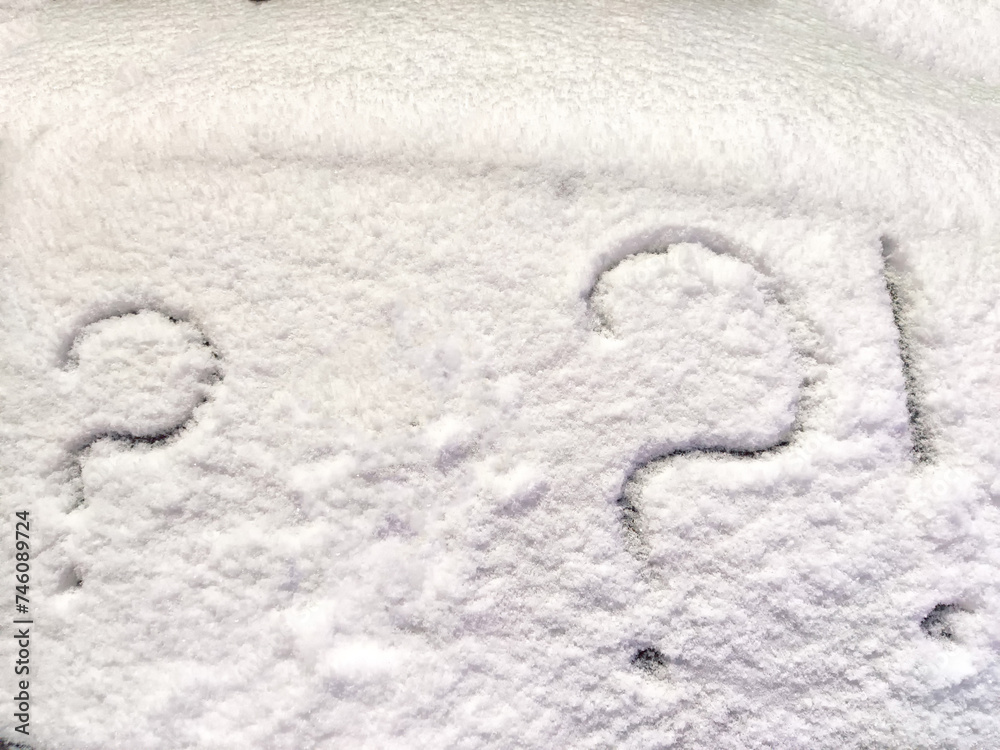 Two question and exclamation marks written in the snow. The cold frosty ...