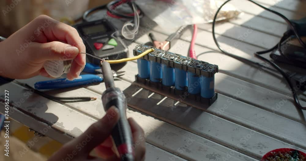 Add lead to melt and stick to the wires.Wires being soldered together ...