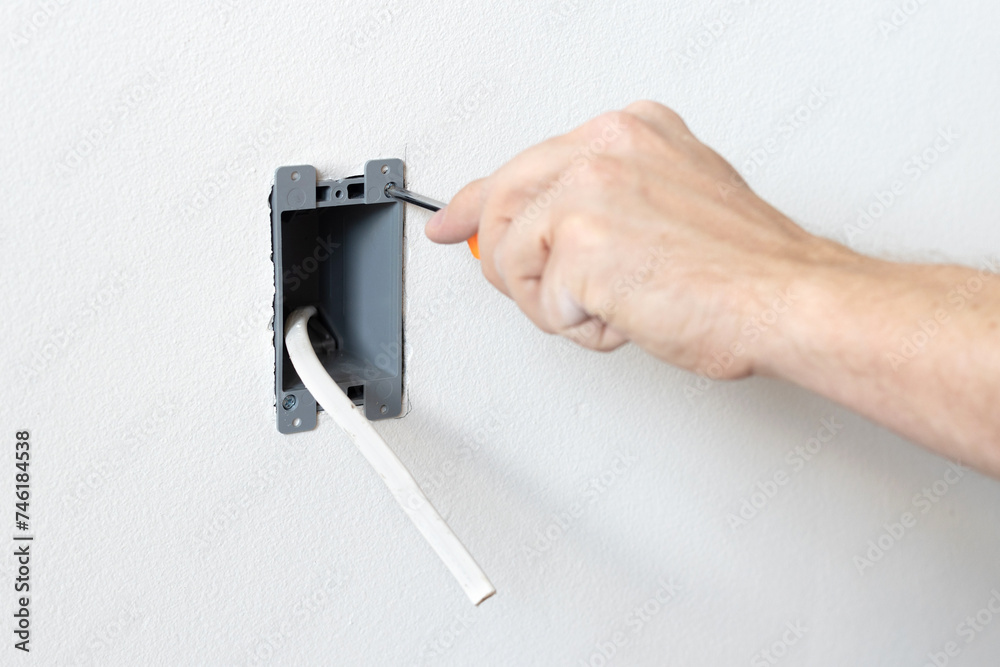 Installing outlet box into the wall. Installing electrical outlet Stock ...