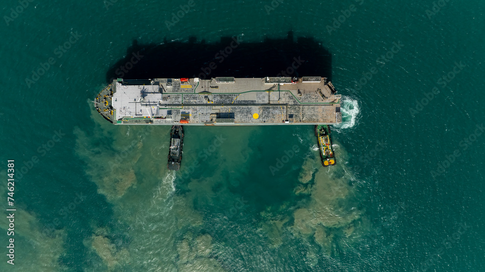 Aerial top view Tugboat pushing dragging Large RoRo (Roll on Roll off ...