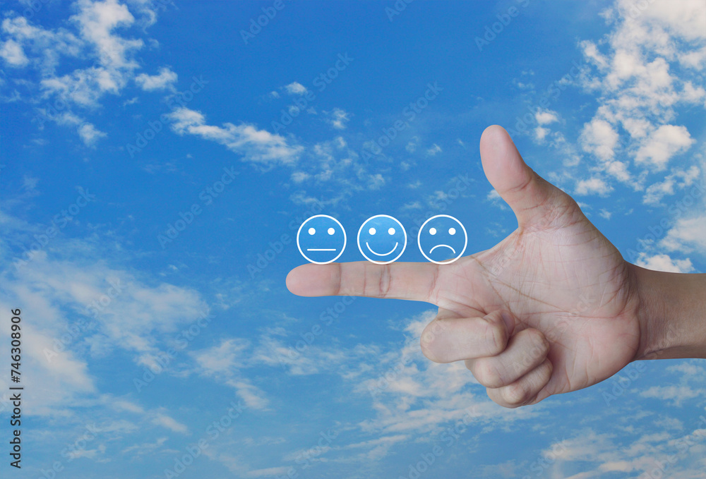 Excellent smiley face rating icon on finger over blue sky, Business ...