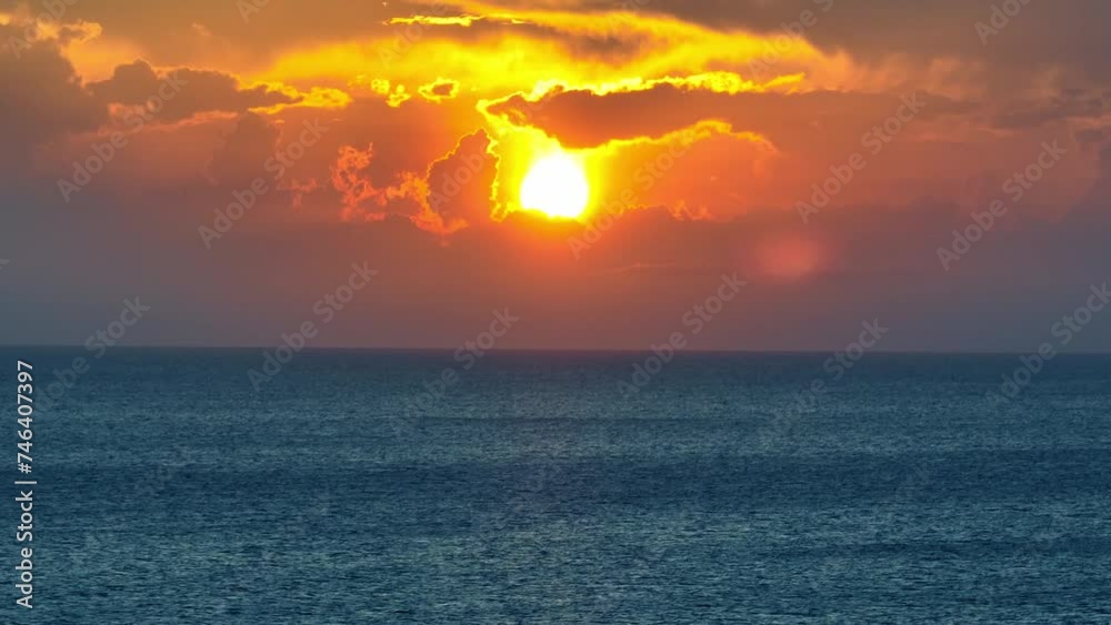 Captured from above, a mesmerizing sunset paints the sky gold, casting ...