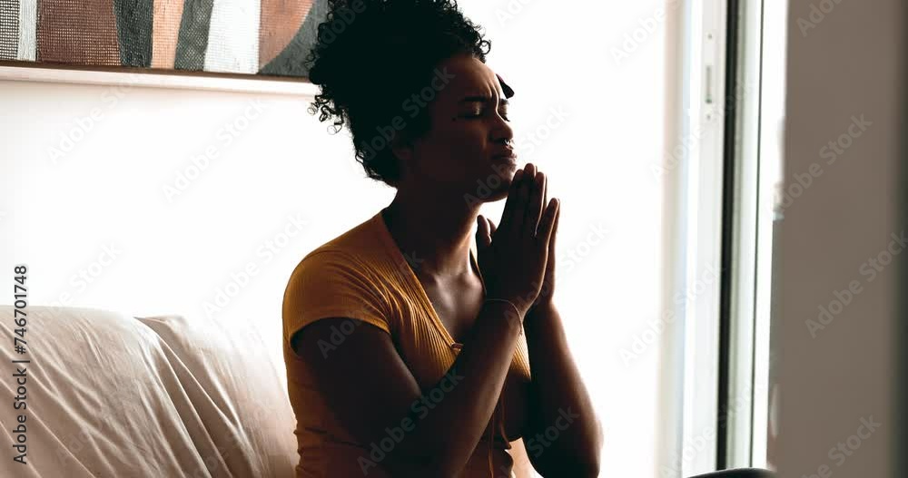 Spiritual young African American young PRAYING to GOD at home raising ...