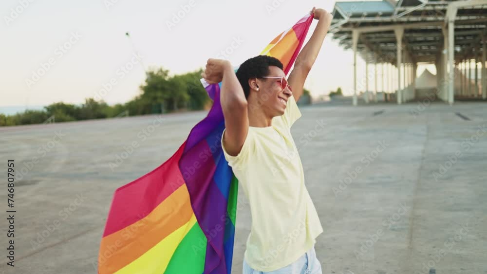 Vidéo Stock Cheerful young black gay man walking celebrating Pride Day ...