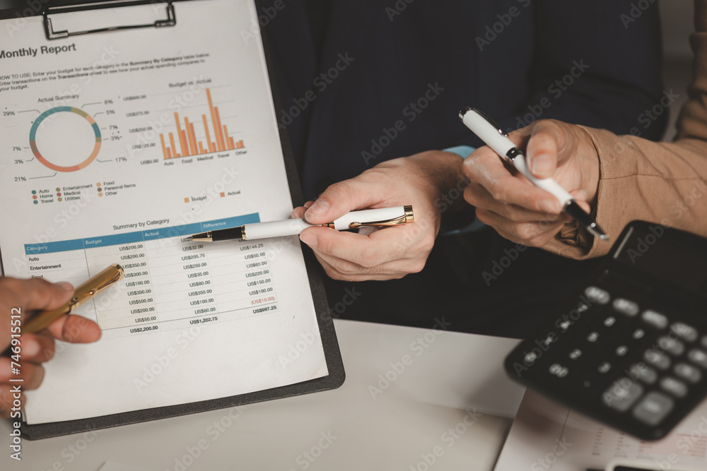 Colleagues scrutinize calculated numbers to discuss which number is ...