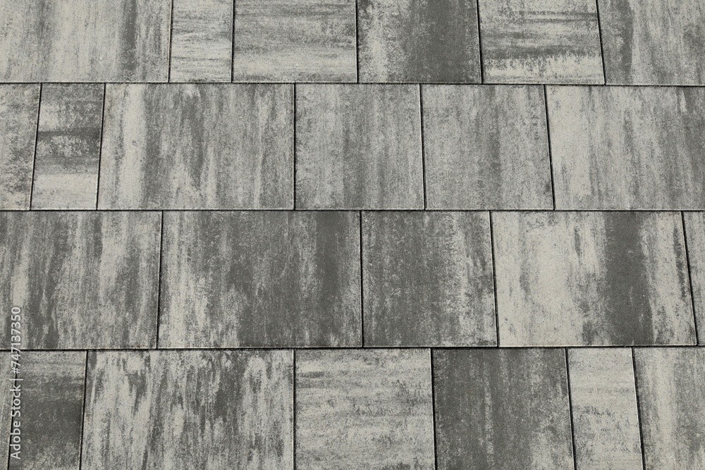Large concrete tiles of different shapes in an outdoor pavements ...